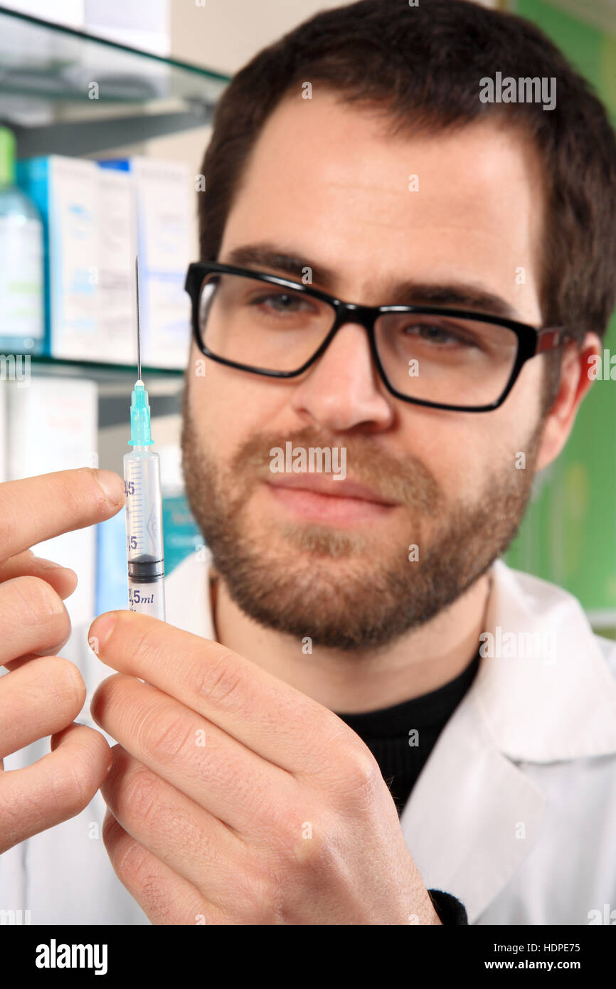 young male pharmacist holding an injection Stock Photo - Alamy