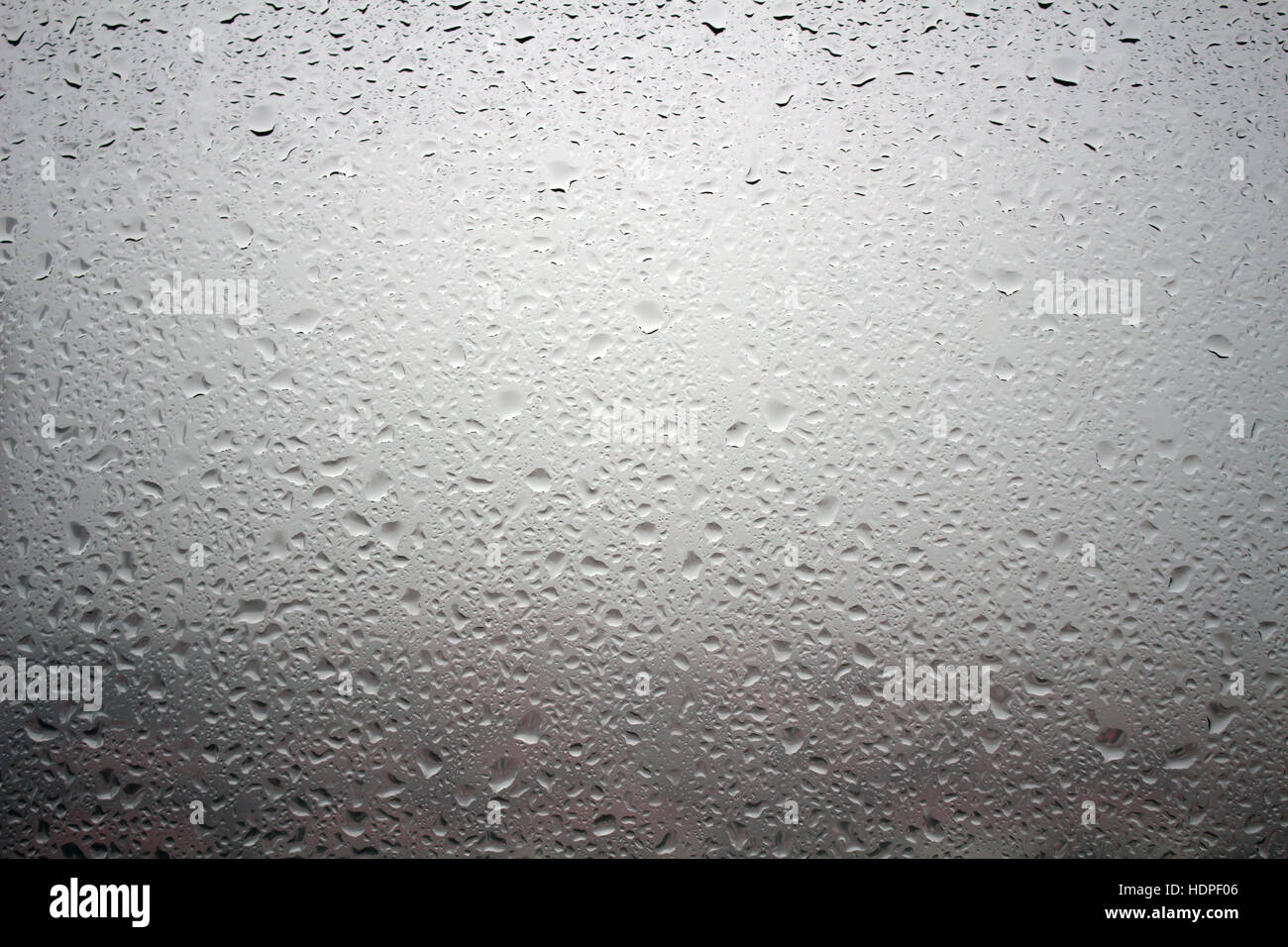 Drops of rain on a window glass with very diffuse landscape natural ...