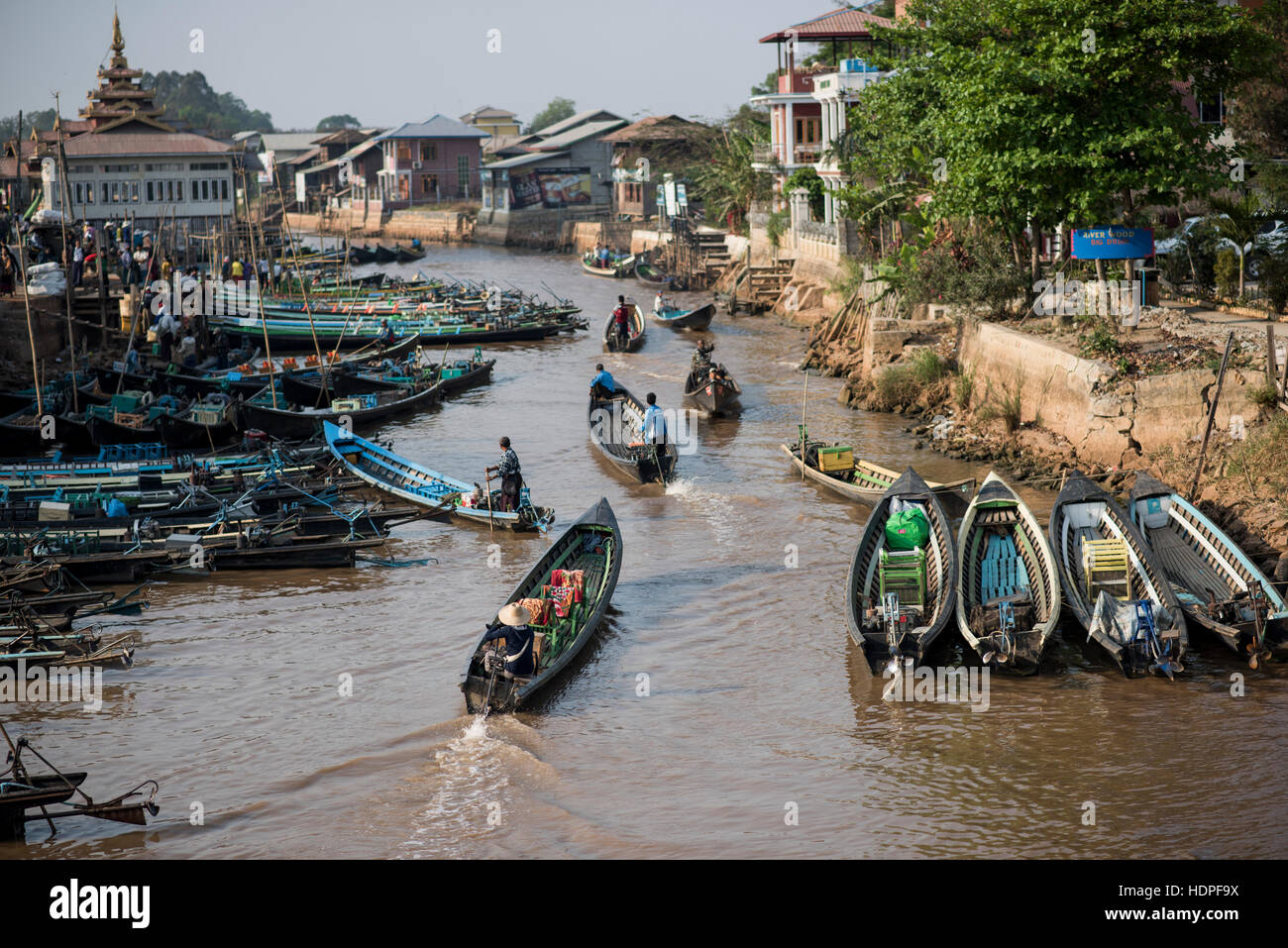 Traditional boats on canal heading to the Inle Lake, Nyaungshwe ...
