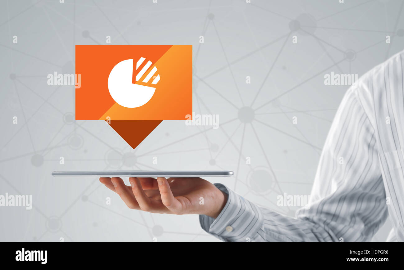 Hand of businessman holding tablet pc with graph icon Stock Photo - Alamy
