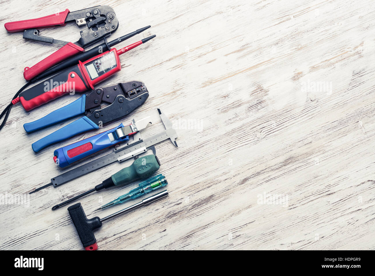 Variety of repair tools on wooden surface Stock Photo - Alamy