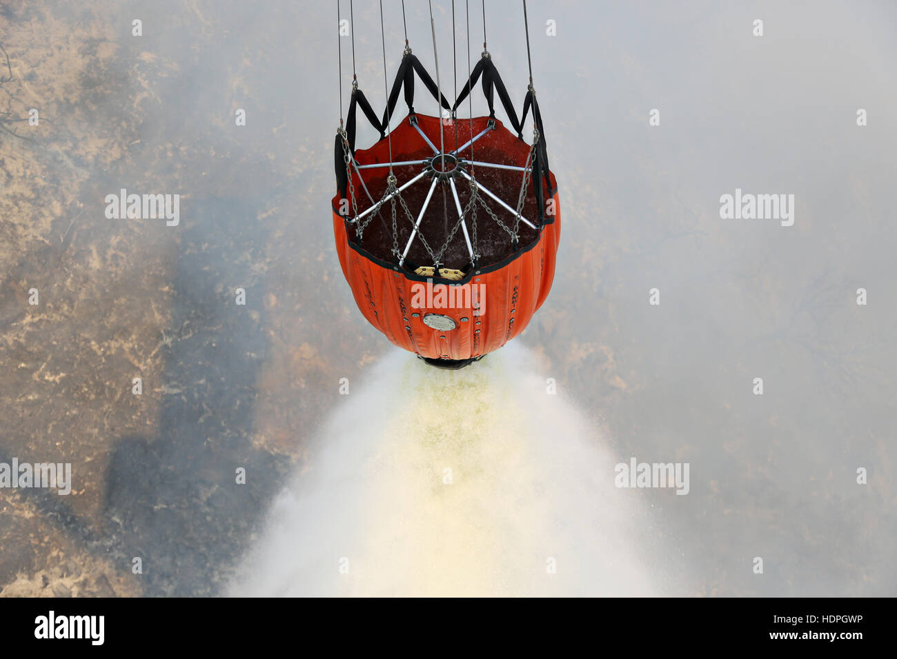 U.S. Marine soldiers drop water from Bambi Buckets on active flames to ...