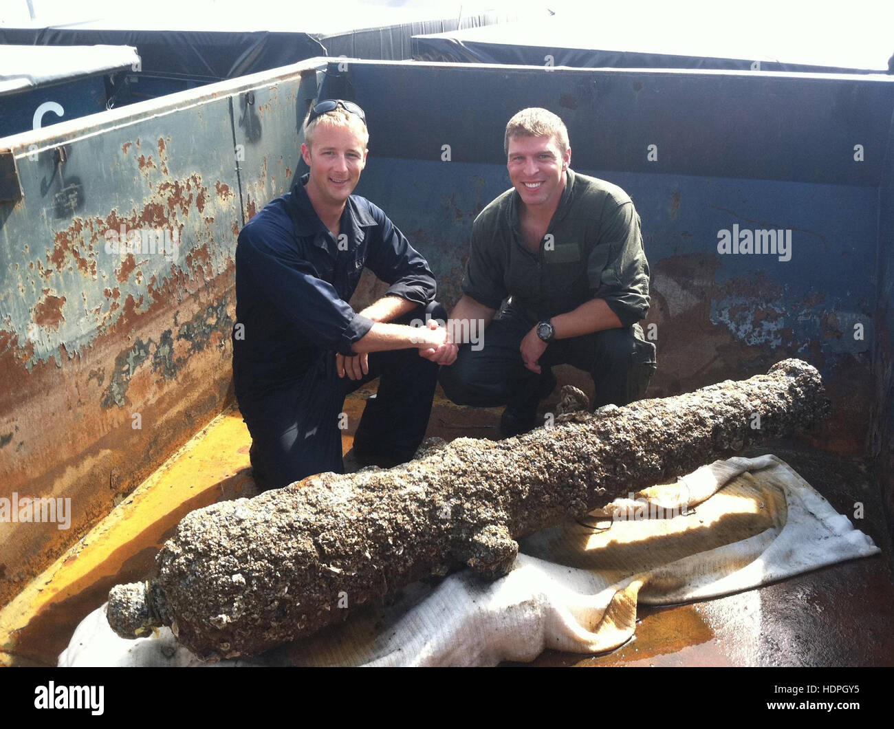 U.S. Navy divers recover a Civil War era cannon from the wreck site of ...