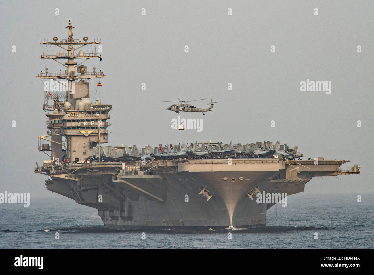 A Sikorsky MH-60S Seahawk helicopter delivers cargo to the USN Nimitz ...