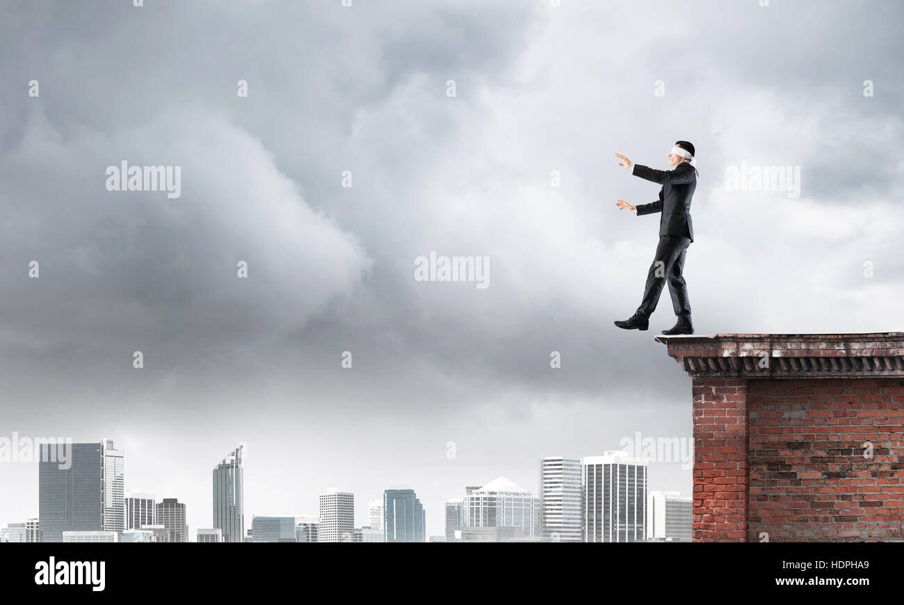 Danger and risk concept with businessman making step from edge Stock ...