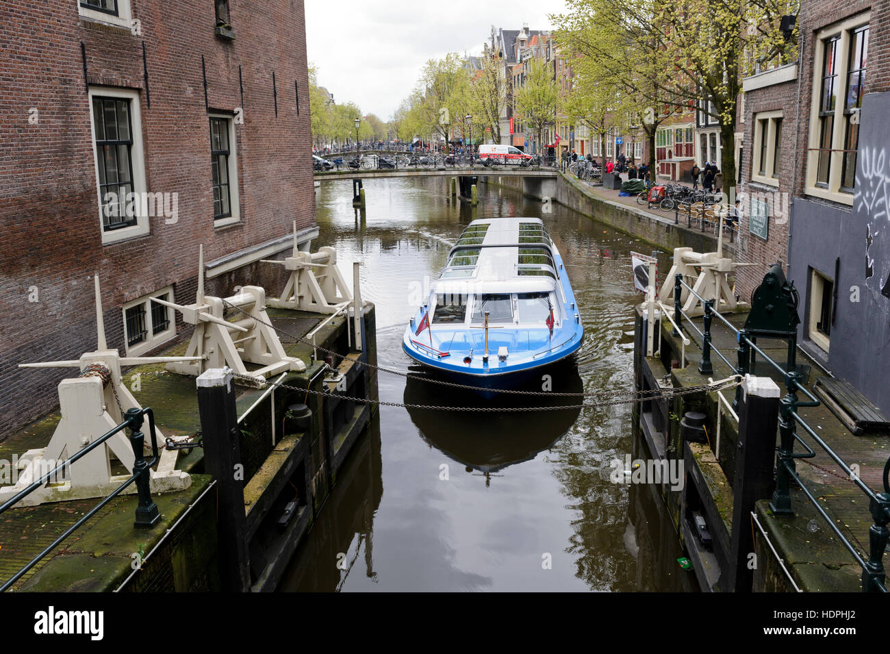 A pleasure boat travelling on the canal in Amsterdsm, holland ...