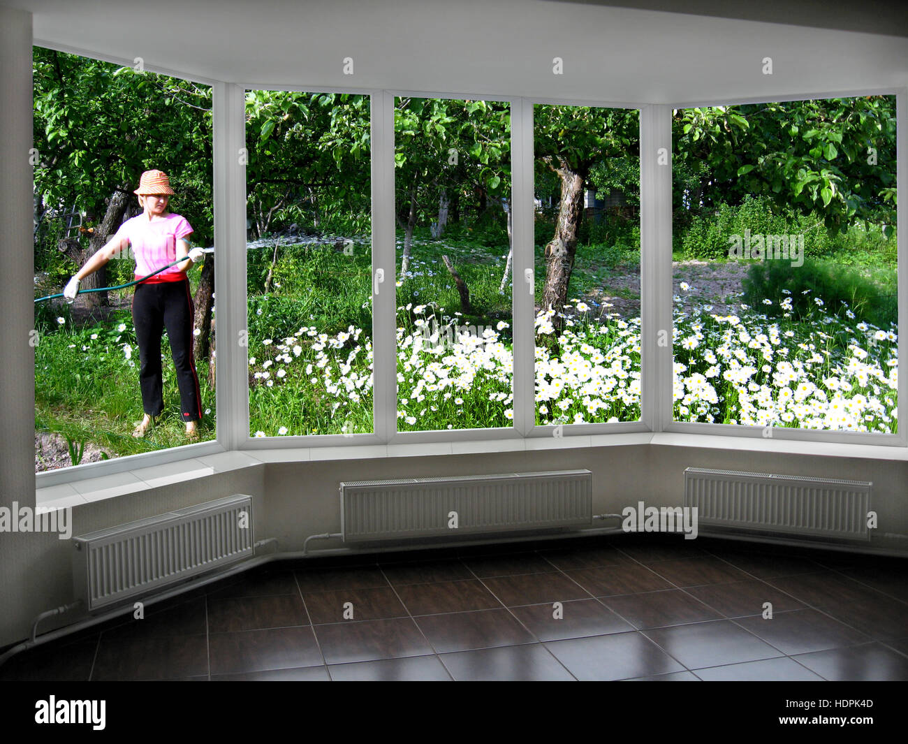 windows of veranda overlooking the garden with watering girl Stock ...