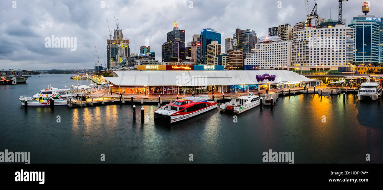 Gray sky and golden light in Sydney Darling harbour Stock Photo - Alamy