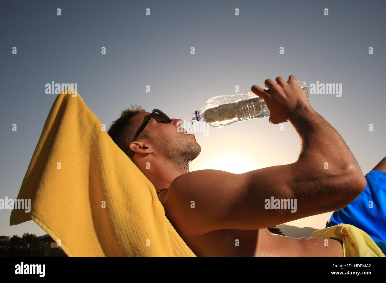 handsome male drinking water at the beach Stock Photo - Alamy