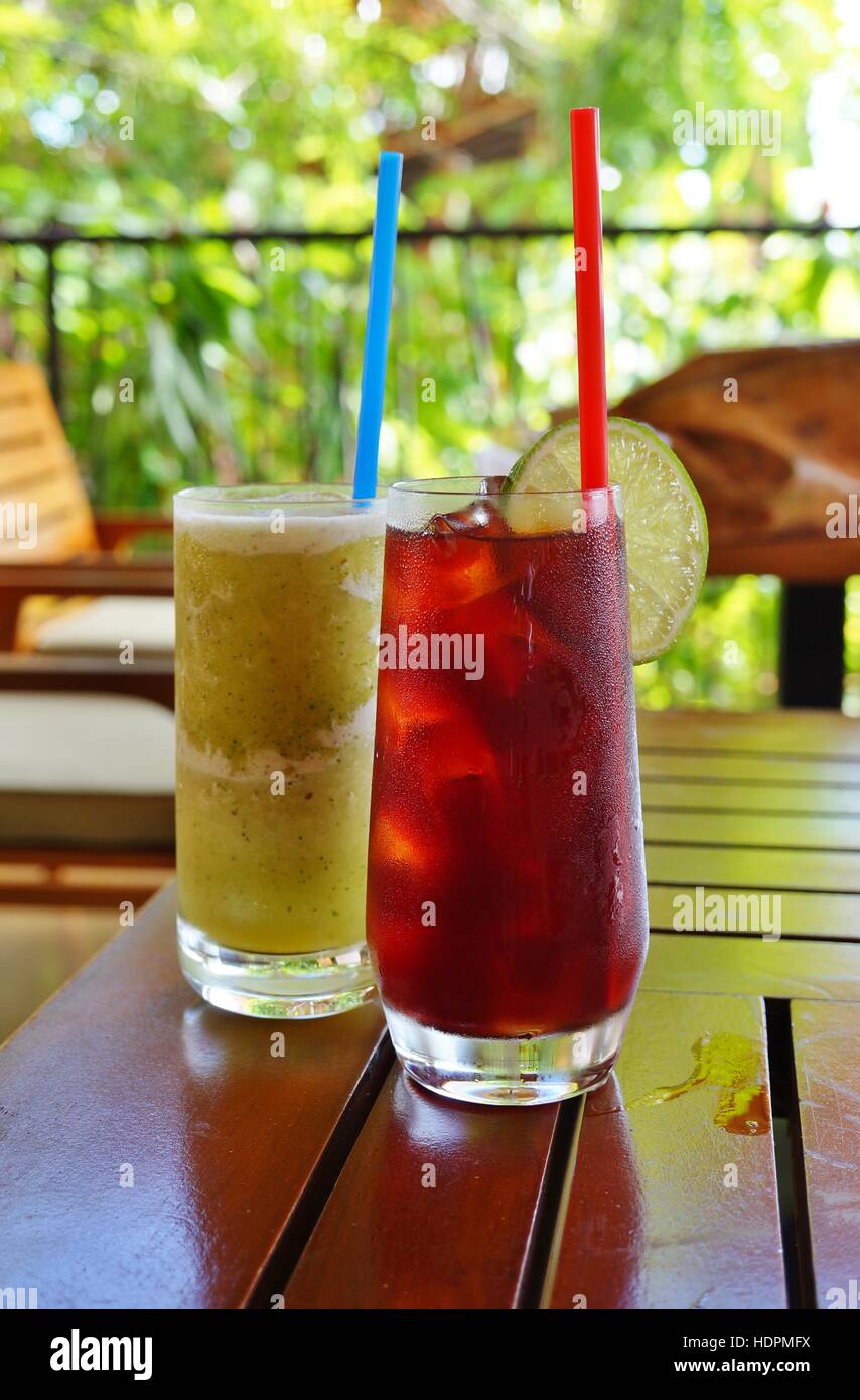 Drinking a green smoothie and an iced tea outdoors in summer Stock ...