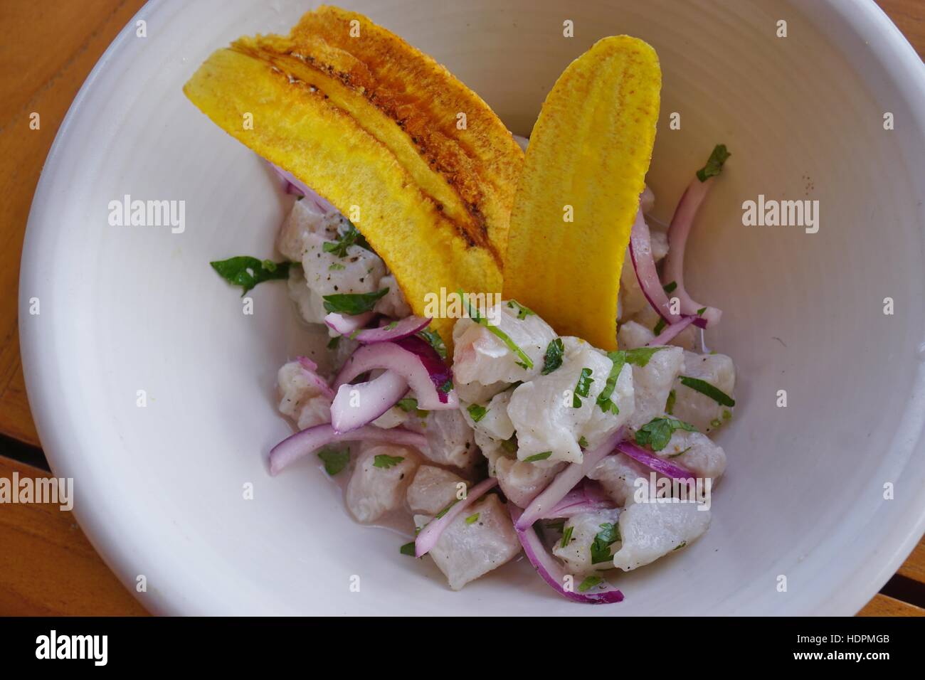 Raw fish ceviche with plantain chips Stock Photo - Alamy