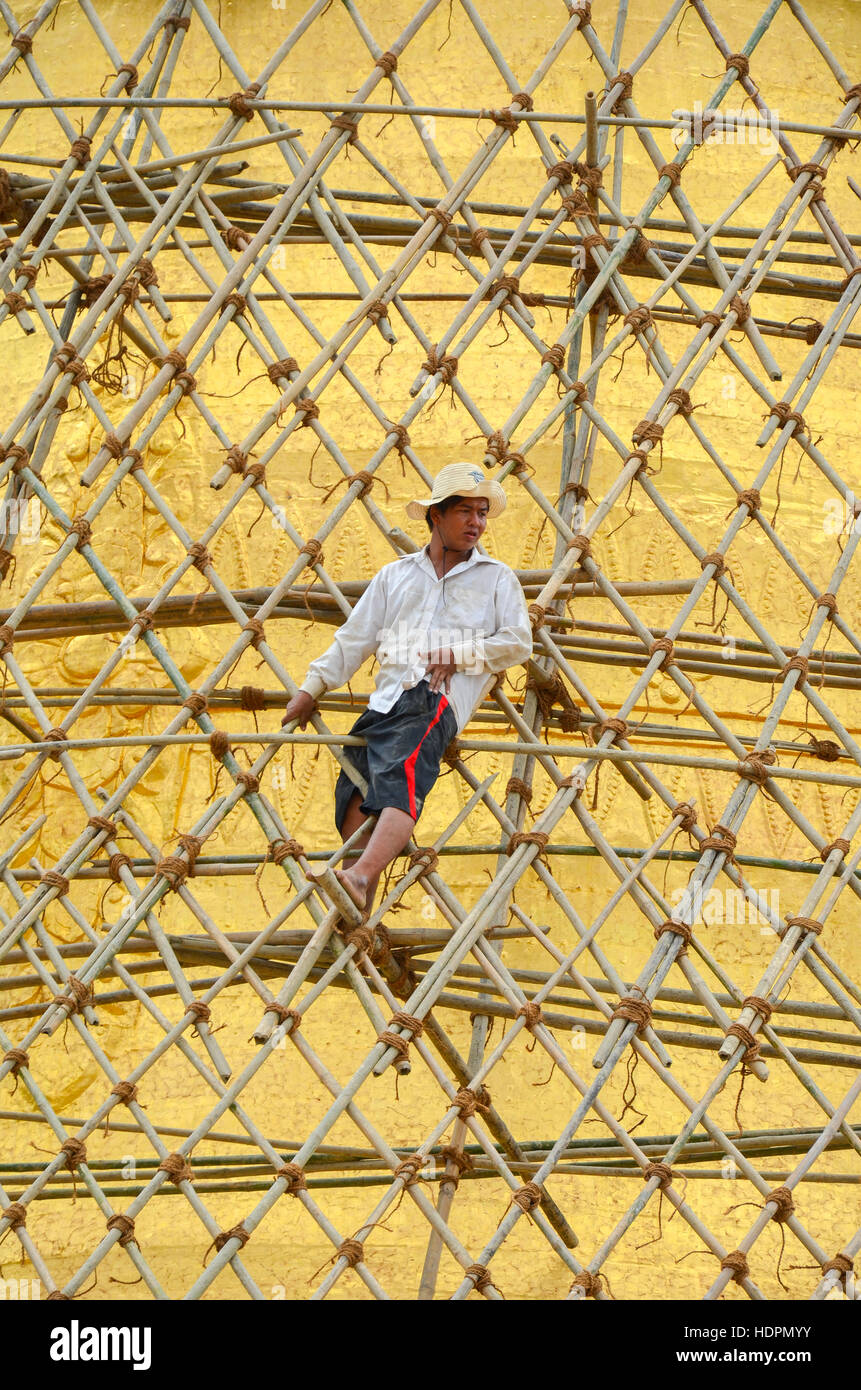 Burmese people building a scaffolding with bamboo for the damaged ...