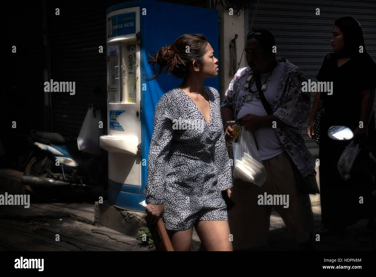 Woman emerging from the shadows of a dark alley way side street ... Woman emerging from the shadows of a dark alley way side street ...
