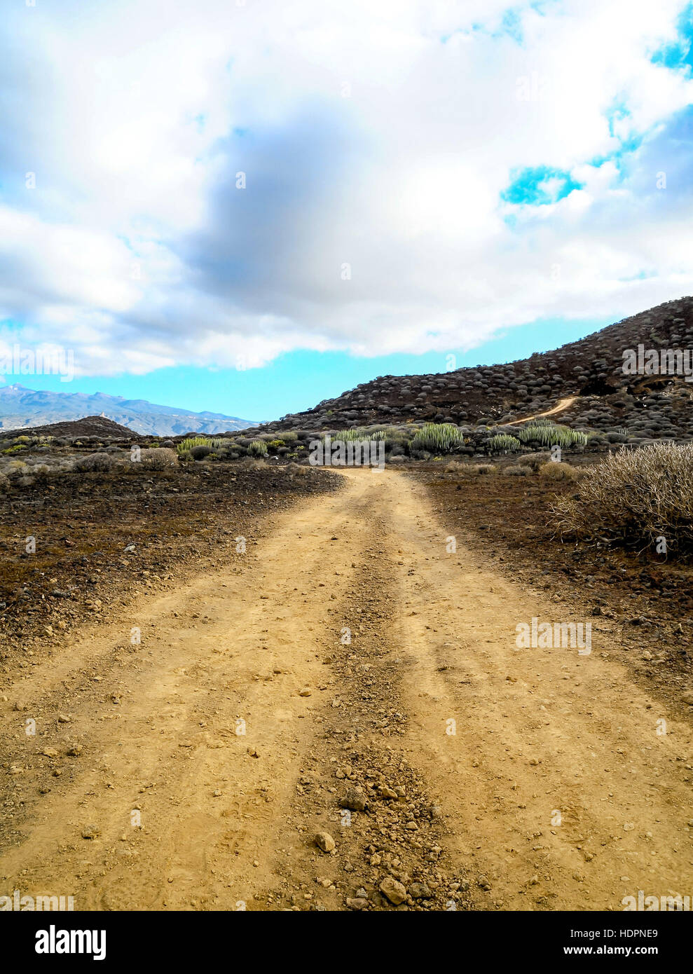Sand and Rocks Road in the Desert on a Cloudy Sky Stock Photo - Alamy
