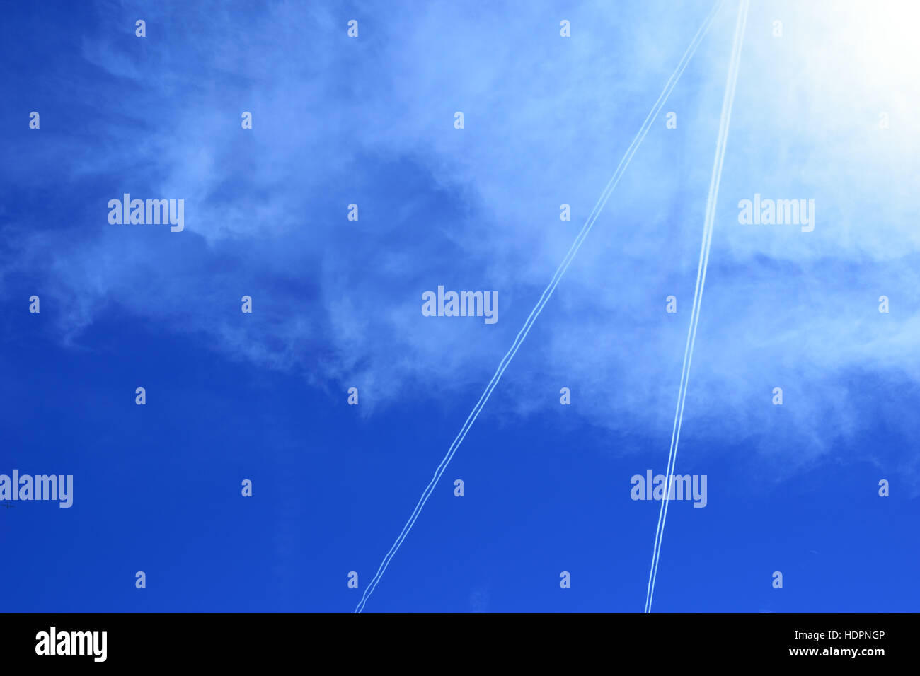 lines of jet streams on blue sky background Stock Photo - Alamy