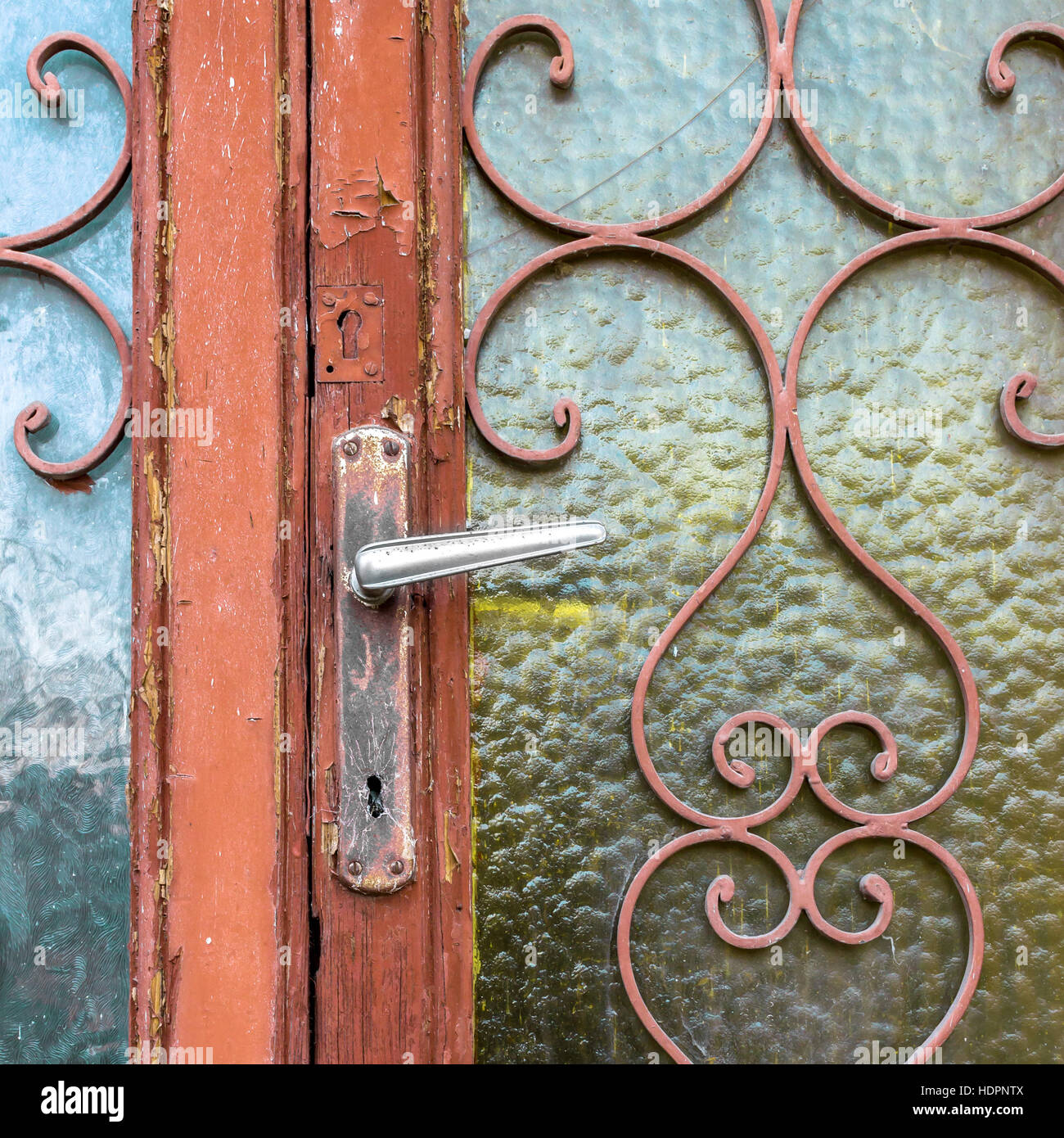 Ancient wooden door with green and blue glass. View on detail of wooden ...