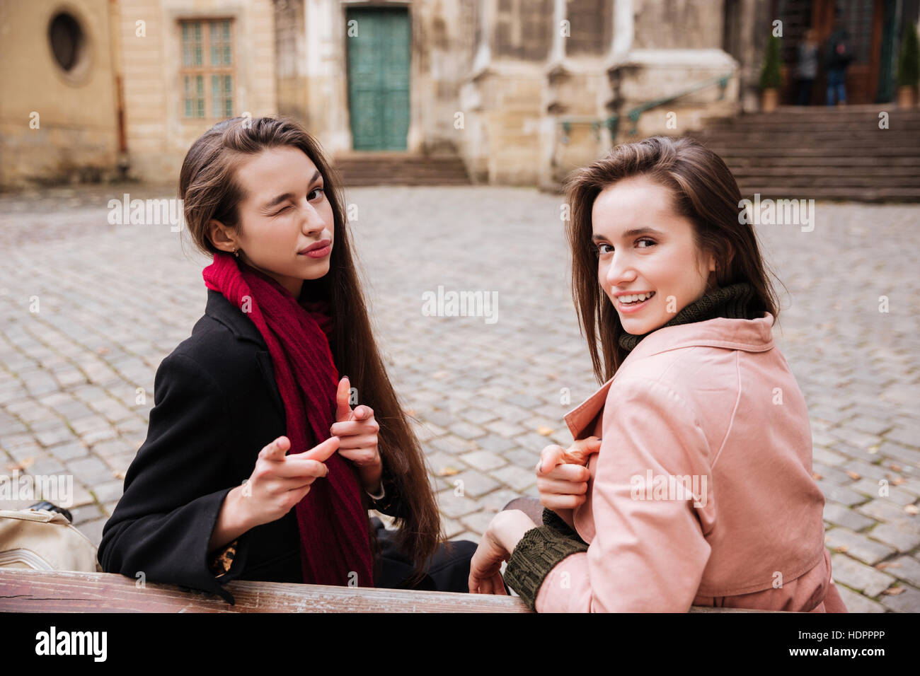 Friends in coats. from the back Stock Photo - Alamy