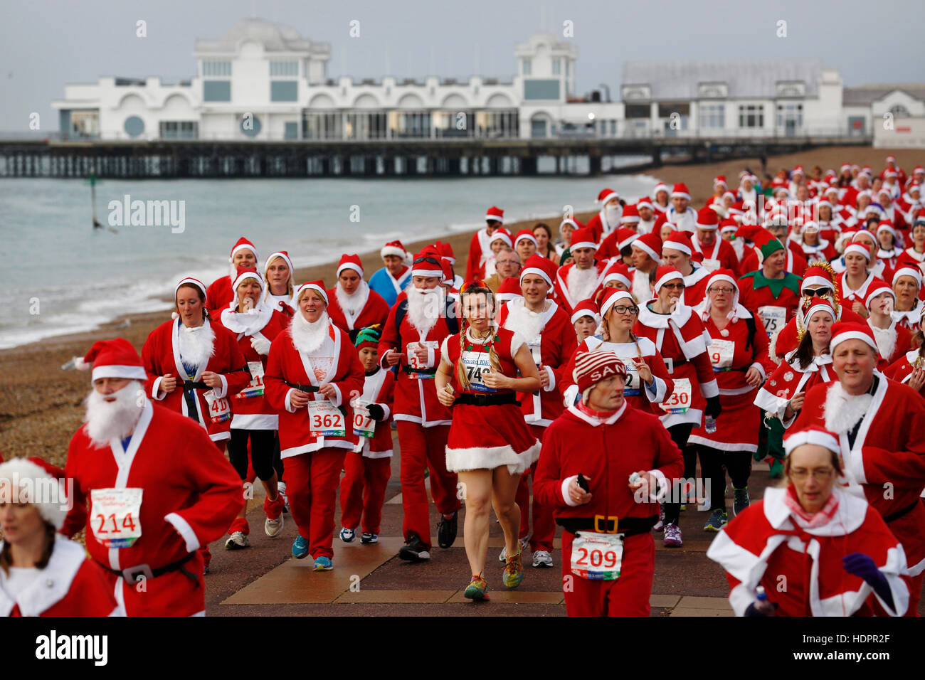 Hundreds of runners dressed as Father Christmas participate in the Portsmouth RNLI 10K Santa Run ...