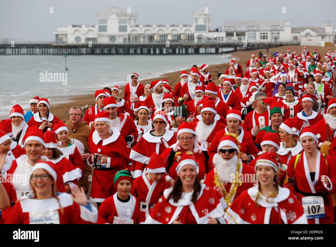 Hundreds of runners dressed as Father Christmas participate in the Portsmouth RNLI 10K Santa Run ...