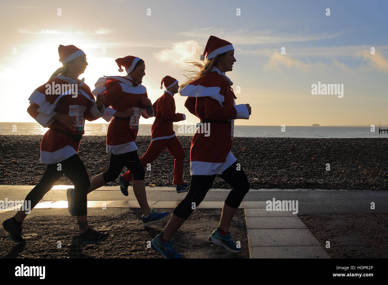 Hundreds of runners dressed as Father Christmas participate in the Portsmouth RNLI 1K Santa Run ...