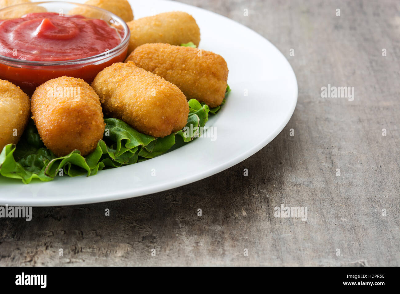 Traditional fried Spanish croquetas (croquettes) with ketchup in plate ...
