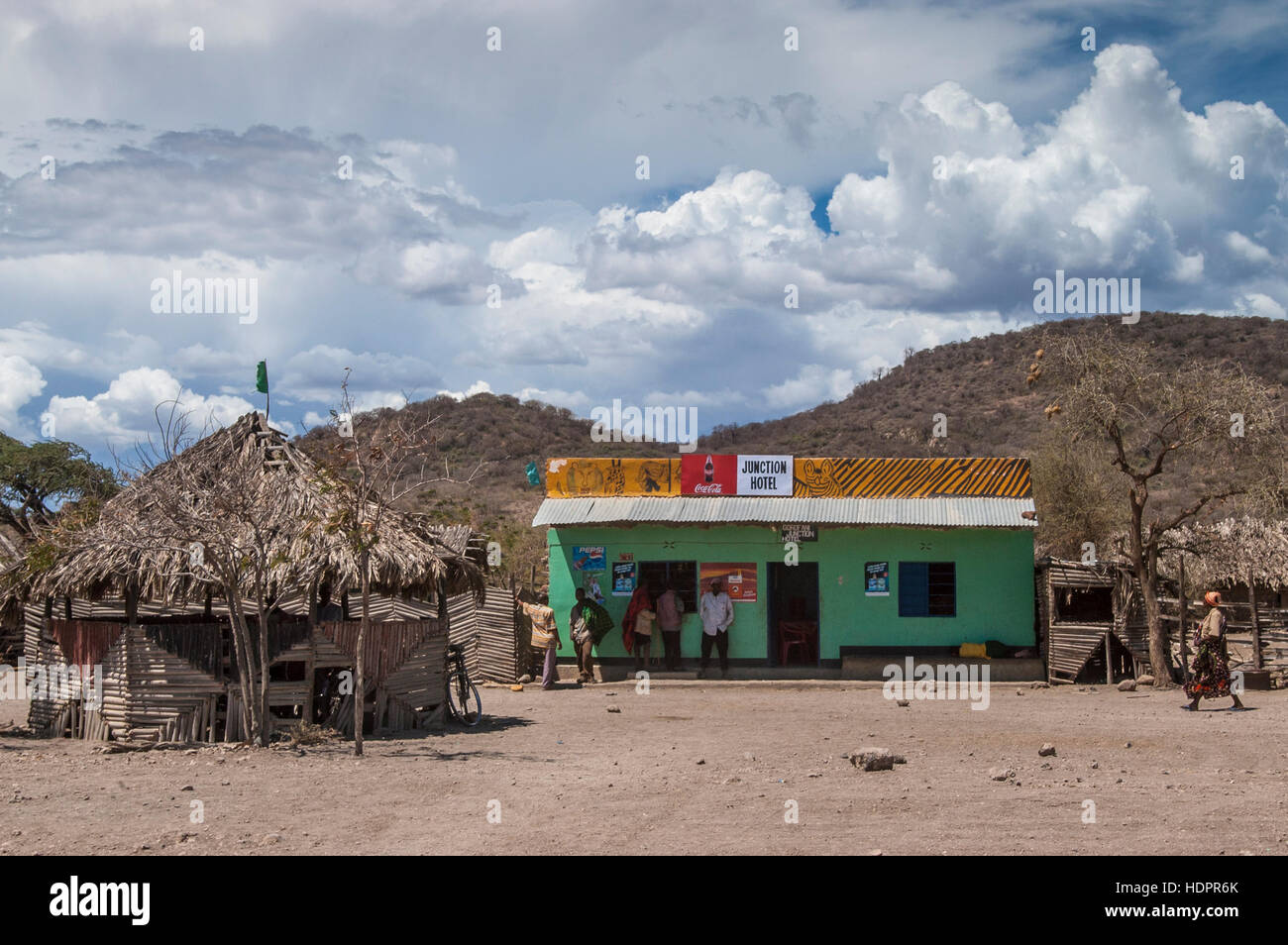 People standing outside a building with grocery and bar, Mangola, Lake ...