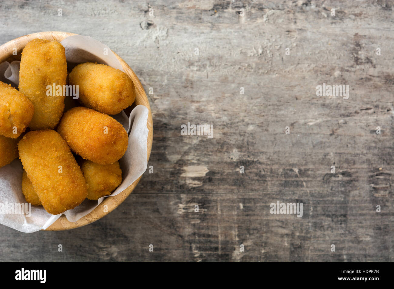 Traditional fried Spanish croquetas (croquettes) on wooden background ...