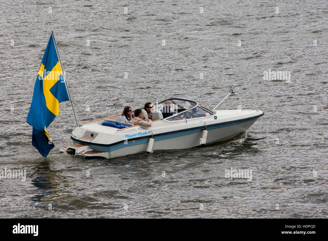 A boat with very large Swedish flag Stock Photo - Alamy