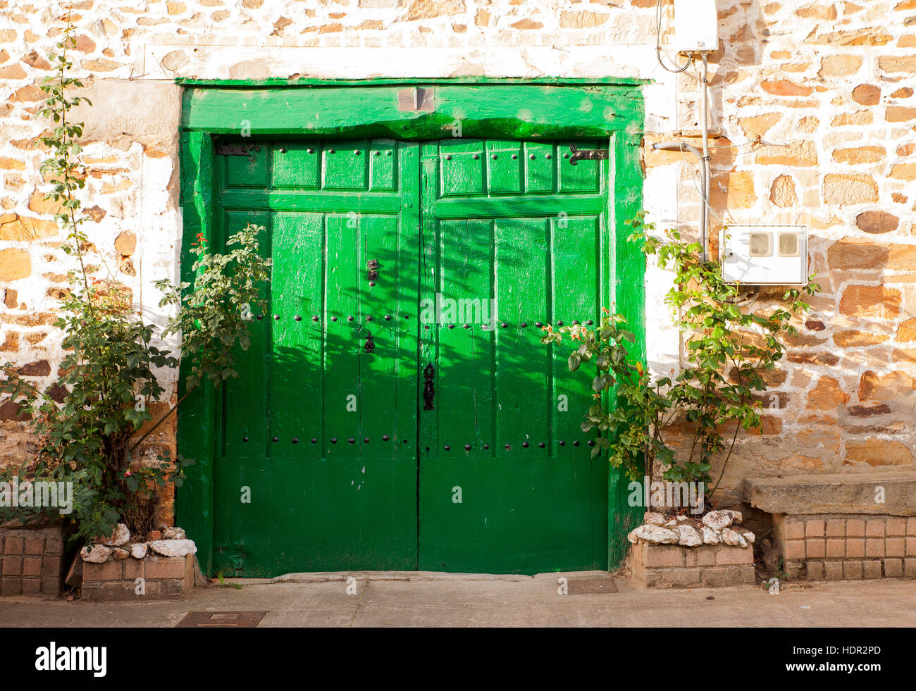 Old green door of a poor Spanish house Stock Photo - Alamy
