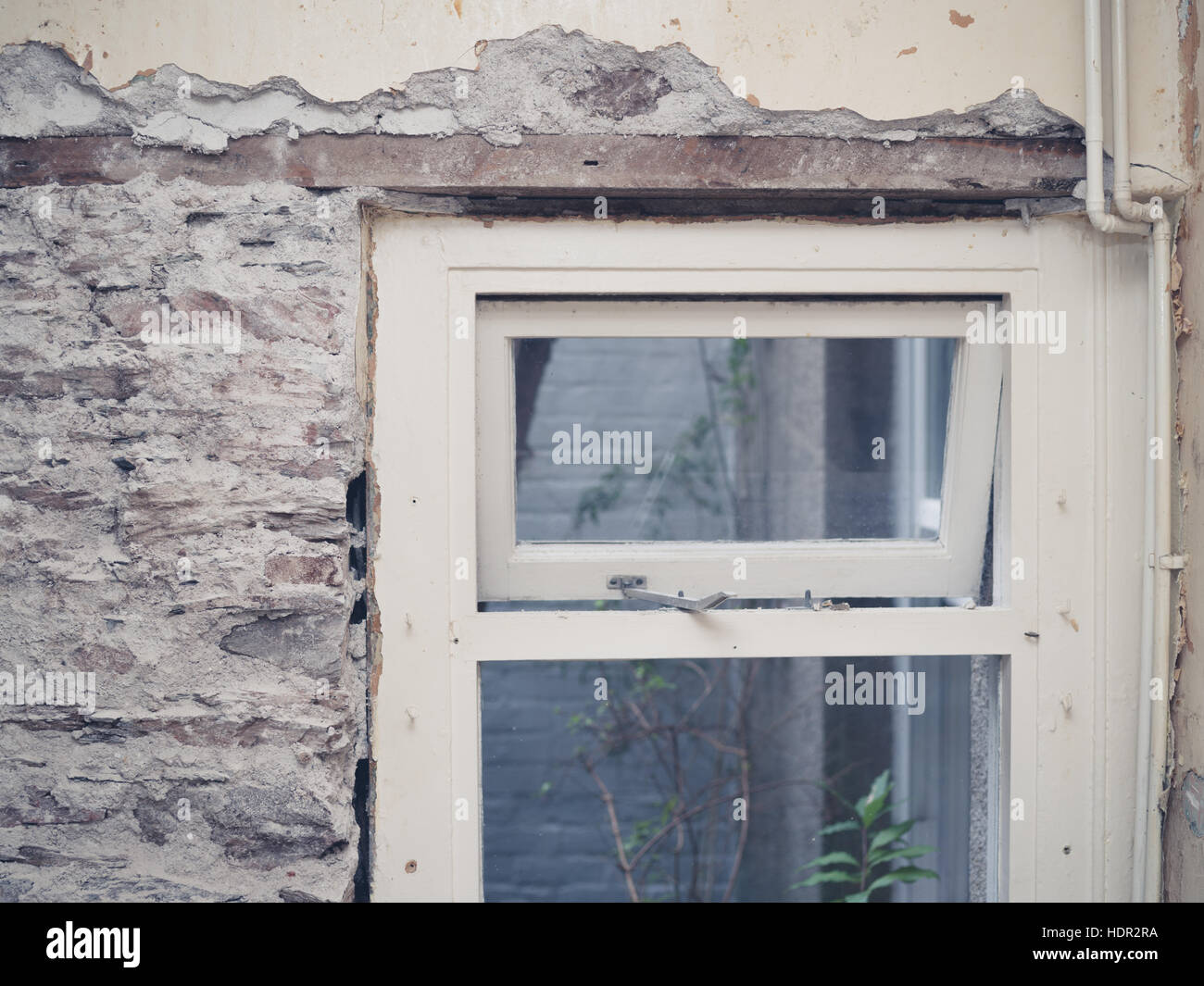 A window in a house with a derelict wall Stock Photo - Alamy