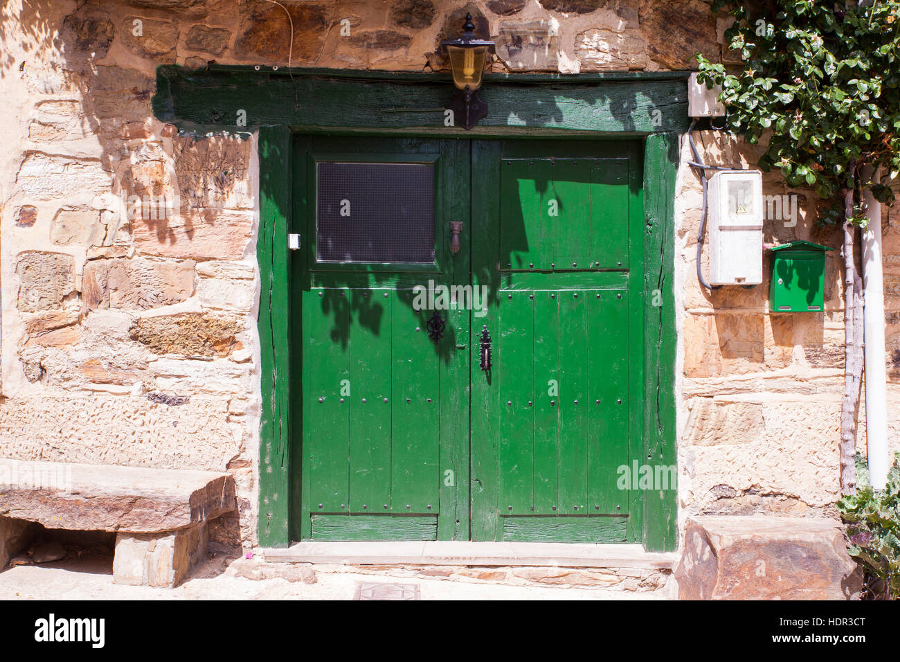 Old green door of a poor Spanish house Stock Photo - Alamy