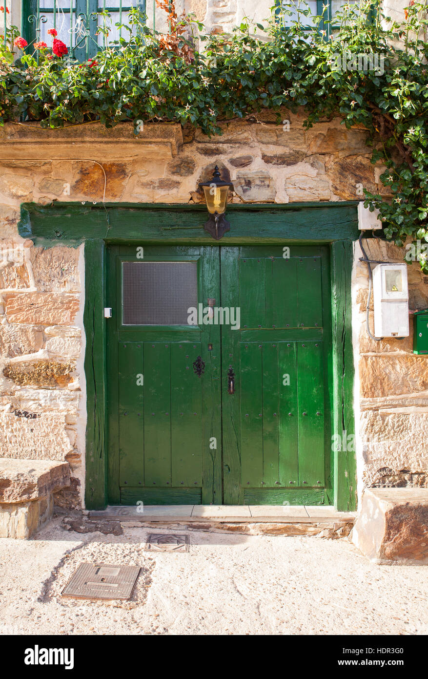 Old green door of a poor Spanish house Stock Photo - Alamy
