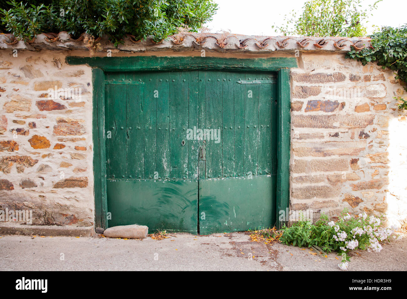 Old green door of a poor Spanish house Stock Photo - Alamy