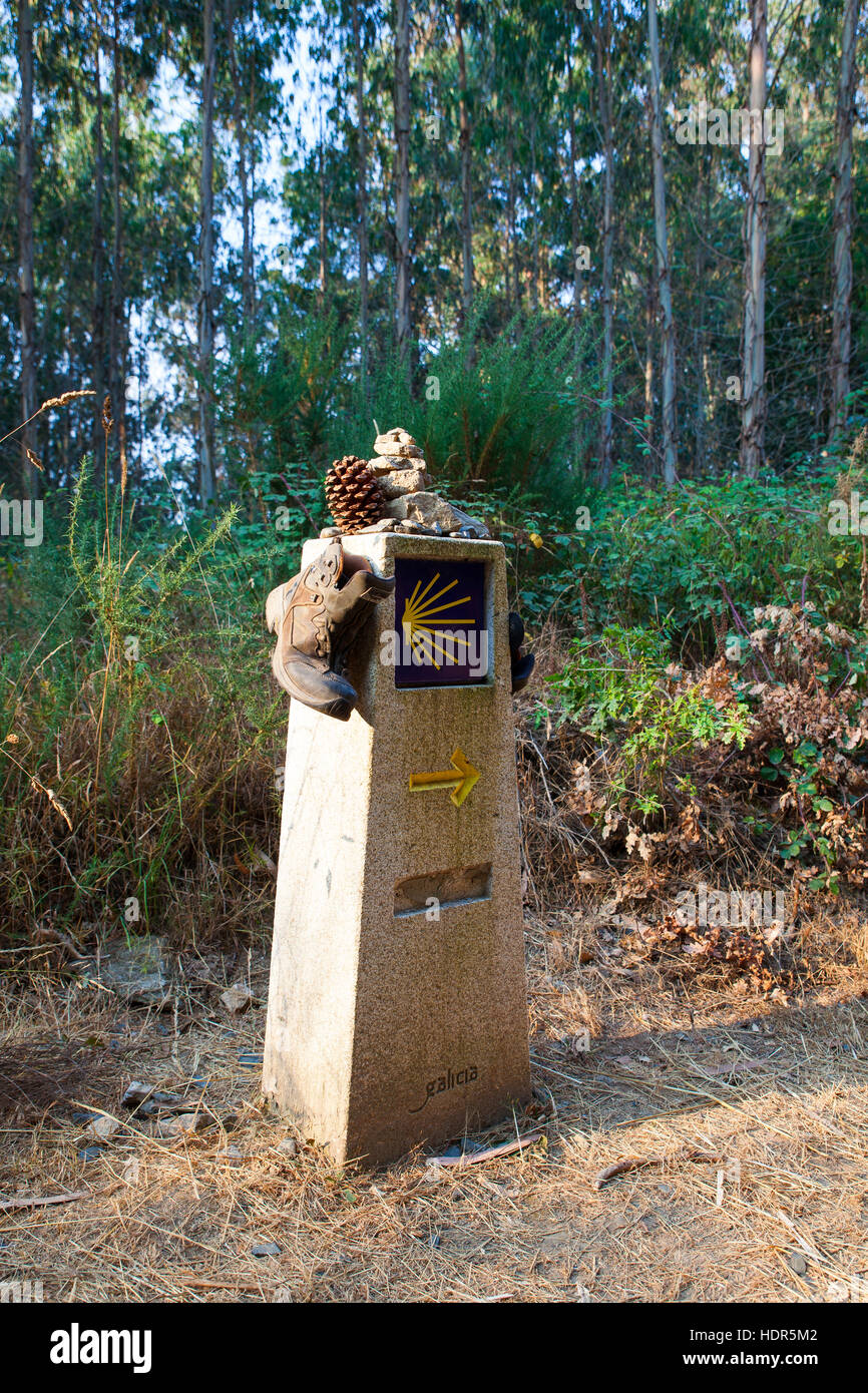 Hiking boots and stone on the stone signal, Symbol of the way of St ...