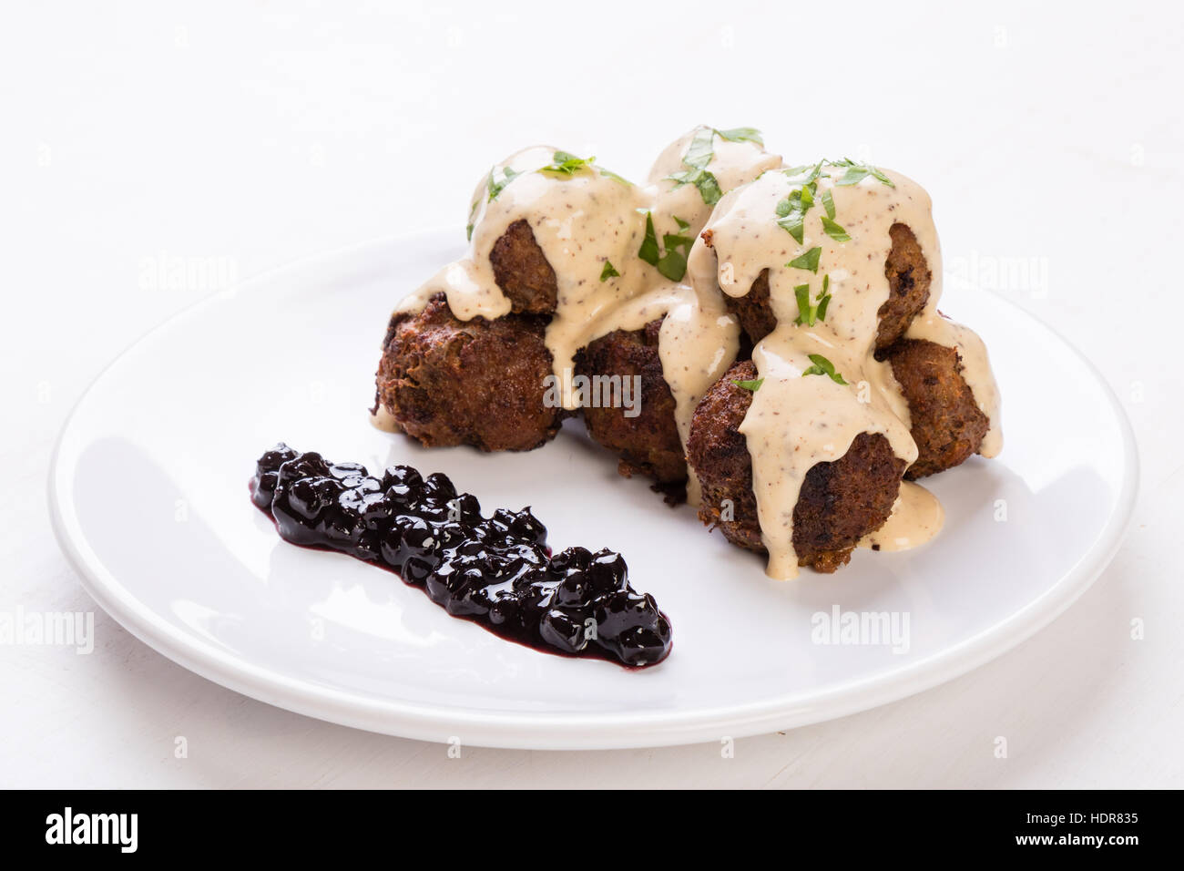 swedish meatballs with blueberry jam on white plate Stock Photo - Alamy