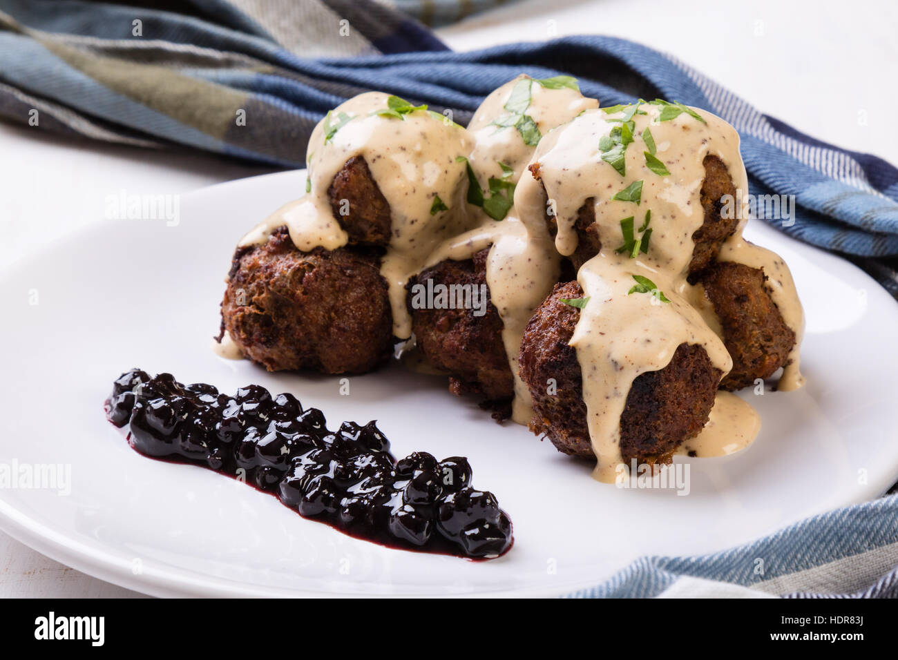 swedish meatballs with blueberry jam on white plate Stock Photo - Alamy