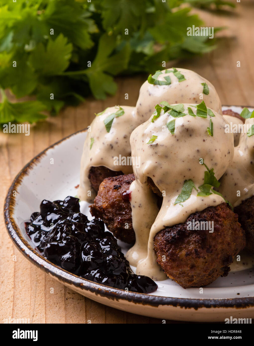 swedish meatballs with blueberry jam on rustic table Stock Photo - Alamy