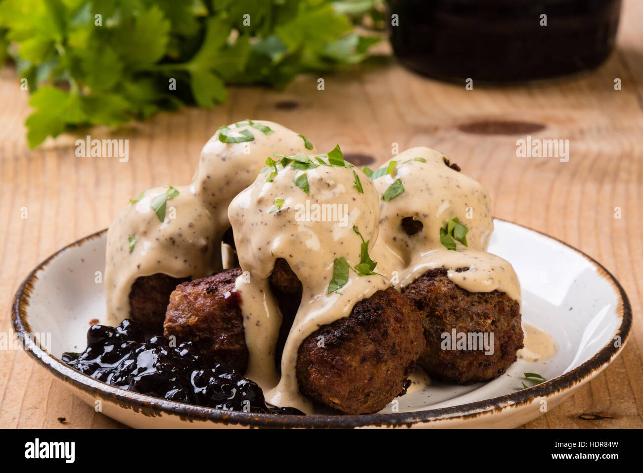 swedish meatballs with blueberry jam on rustic table Stock Photo - Alamy