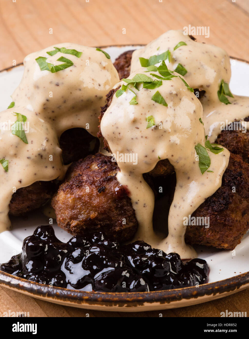 swedish meatballs with blueberry jam on rustic table Stock Photo - Alamy