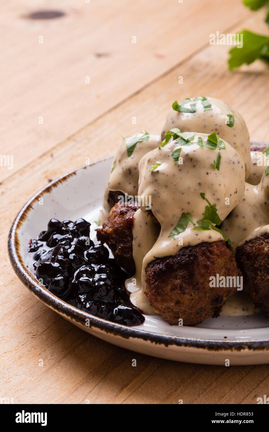 swedish meatballs with blueberry jam on rustic table Stock Photo - Alamy