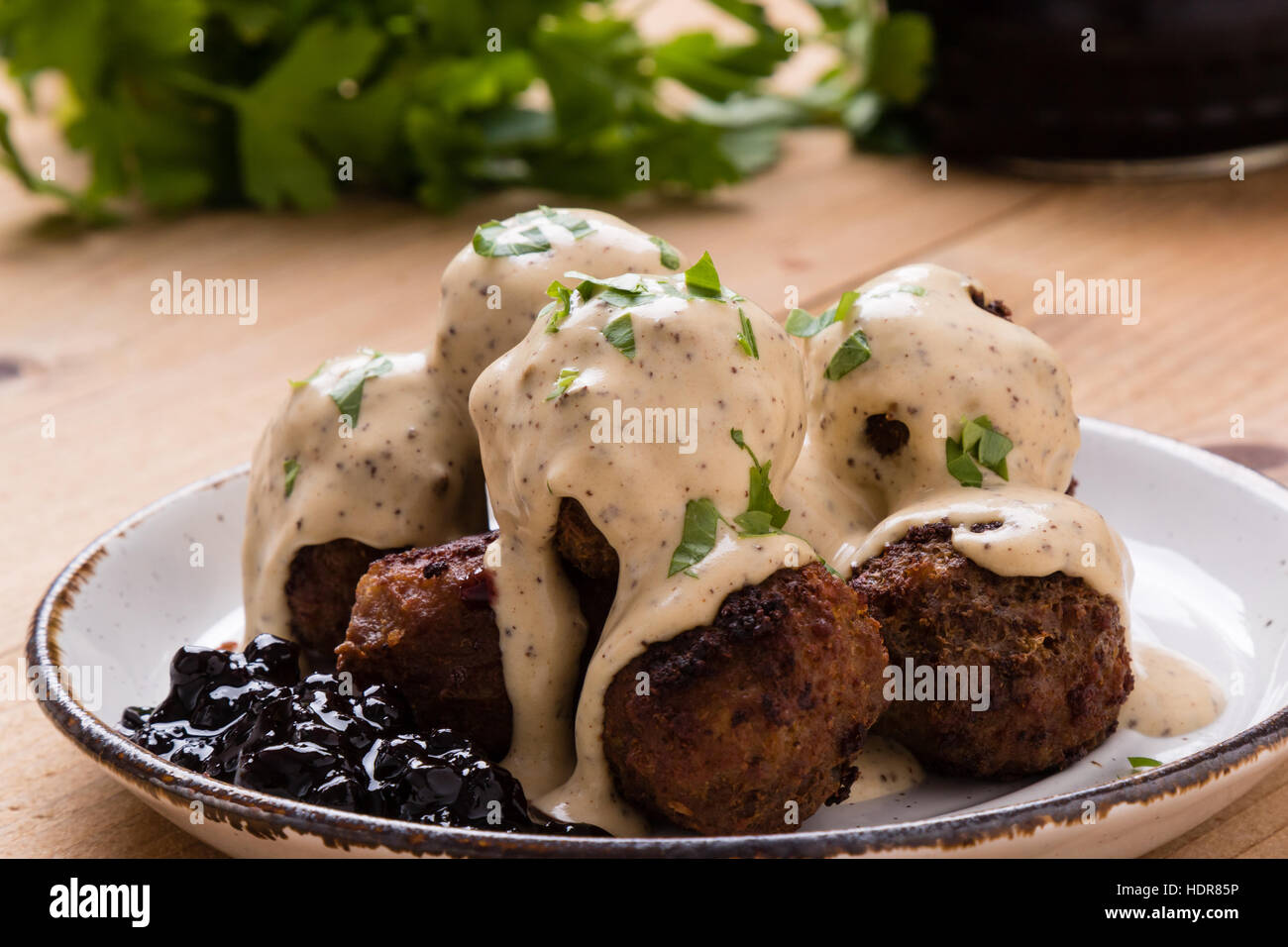 swedish meatballs with blueberry jam on rustic table Stock Photo - Alamy