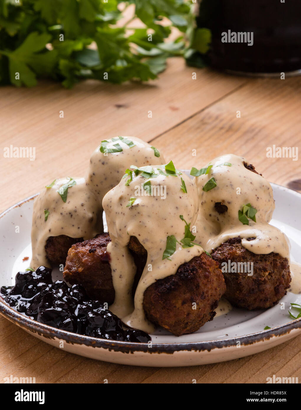 swedish meatballs with blueberry jam on rustic table Stock Photo - Alamy