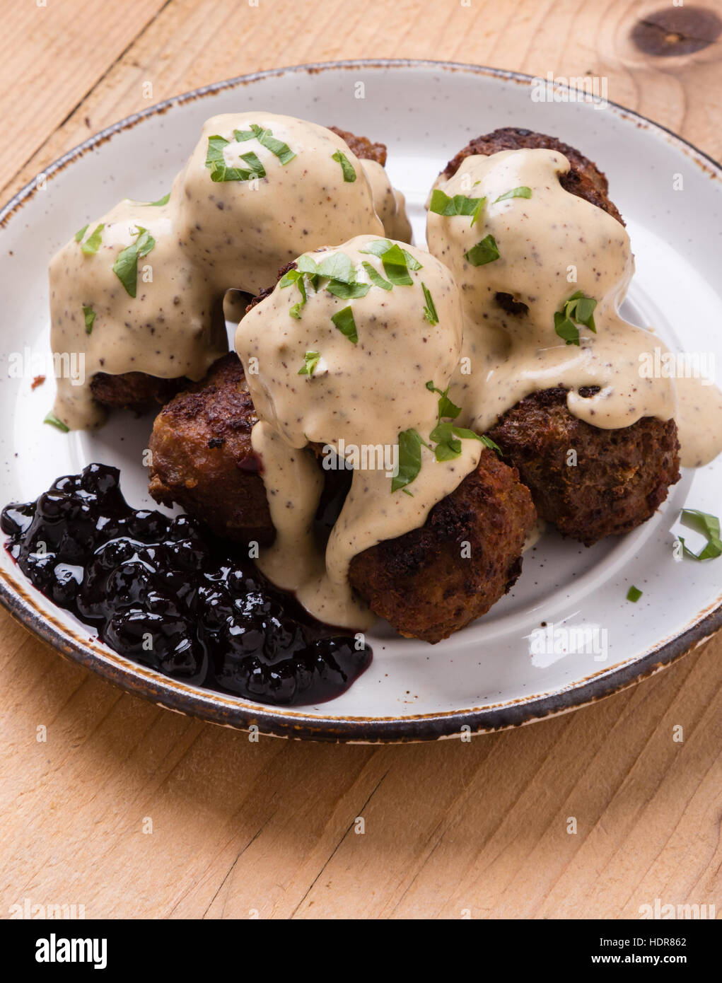 swedish meatballs with blueberry jam on rustic table Stock Photo - Alamy