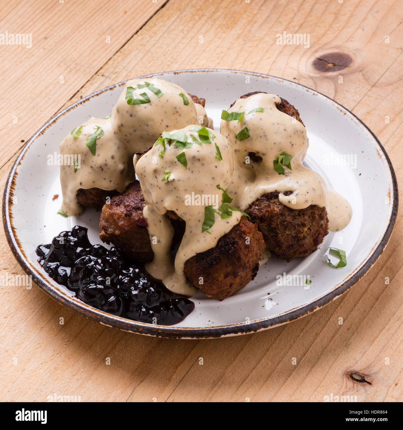 swedish meatballs with blueberry jam on rustic table Stock Photo - Alamy