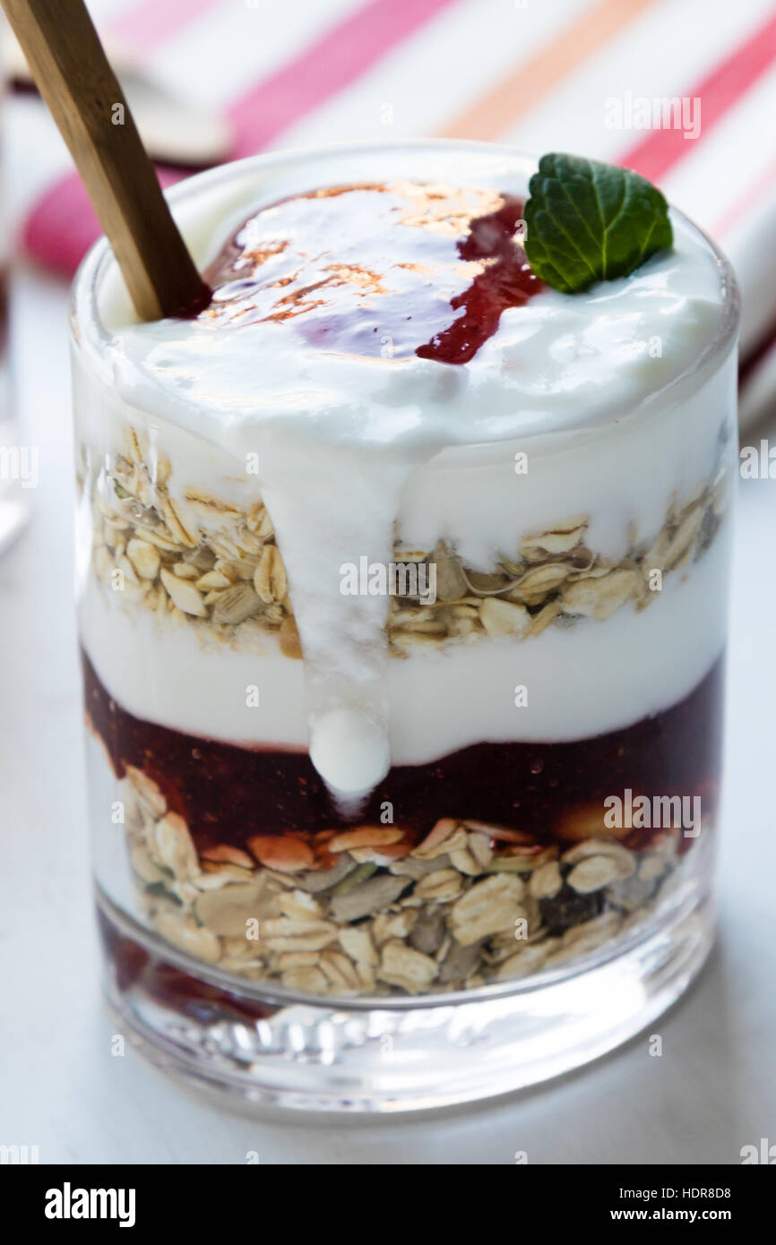 healthy yogurt parfait with jam in glass on white table Stock Photo - Alamy