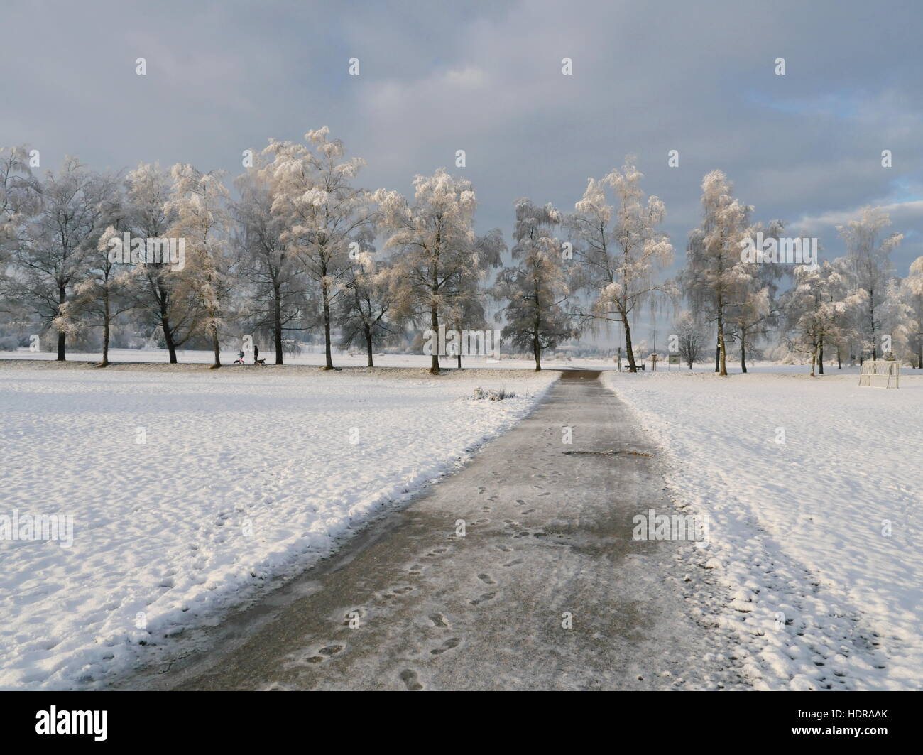 Winter road with footsteps Stock Photo - Alamy