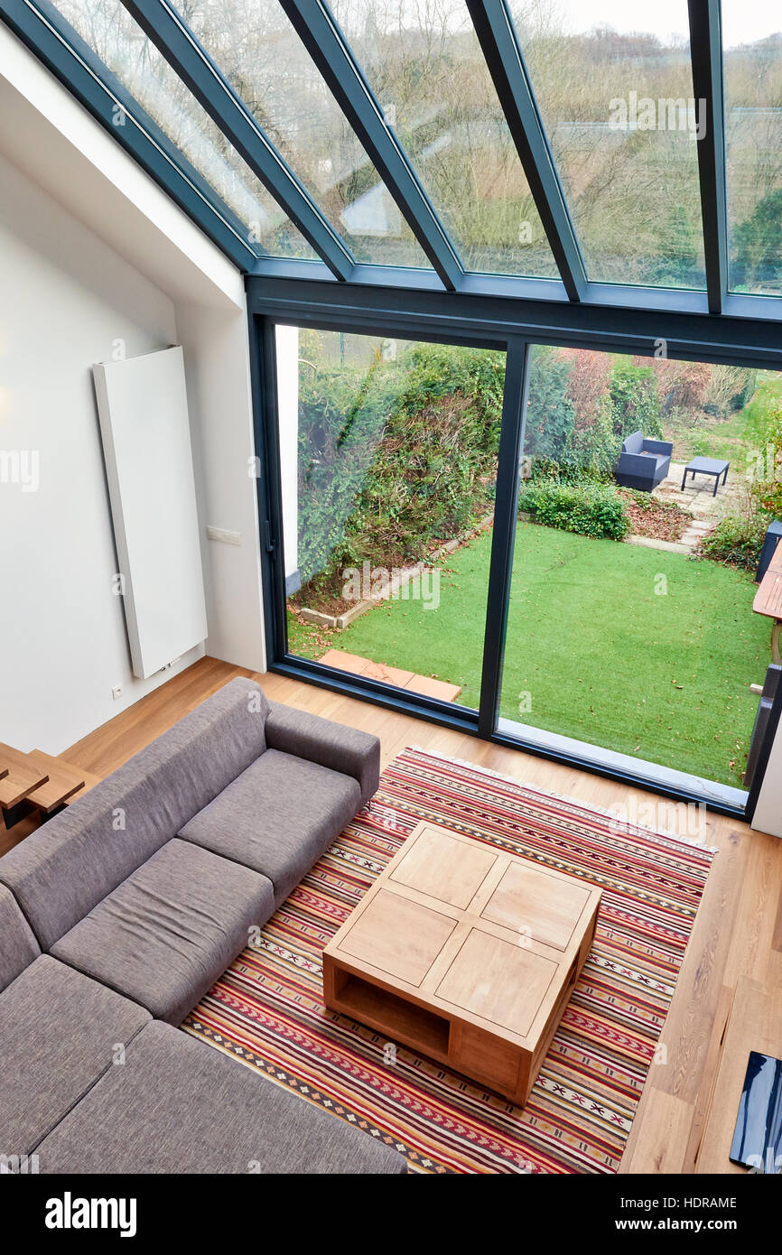 Modern living room with large windows and view on a autumnal garden ...