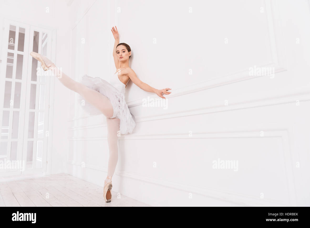 Graceful classical dancer stretching her left leg Stock Photo - Alamy
