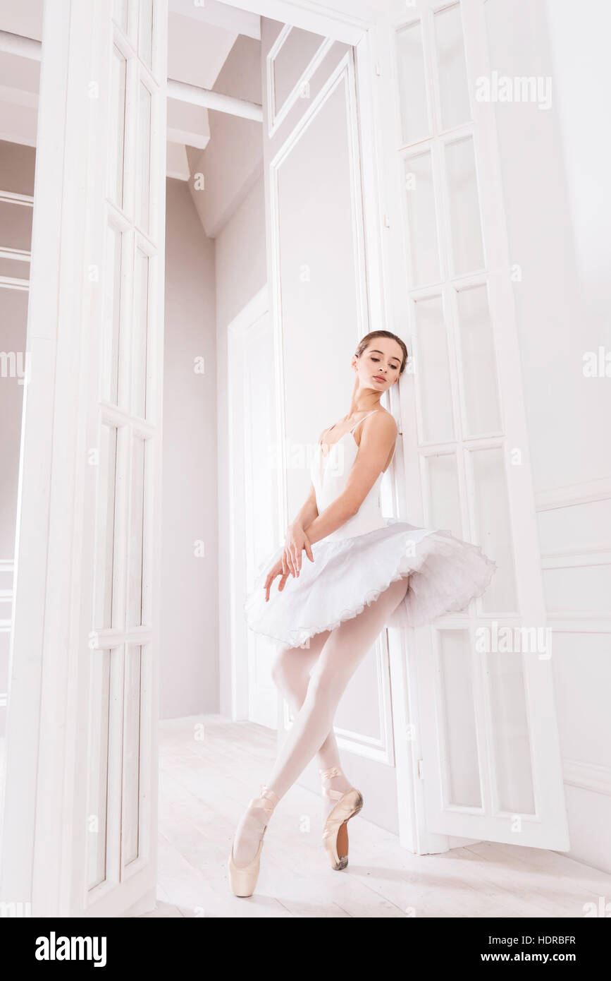 Elegant ballerina holding her legs crossed Stock Photo - Alamy