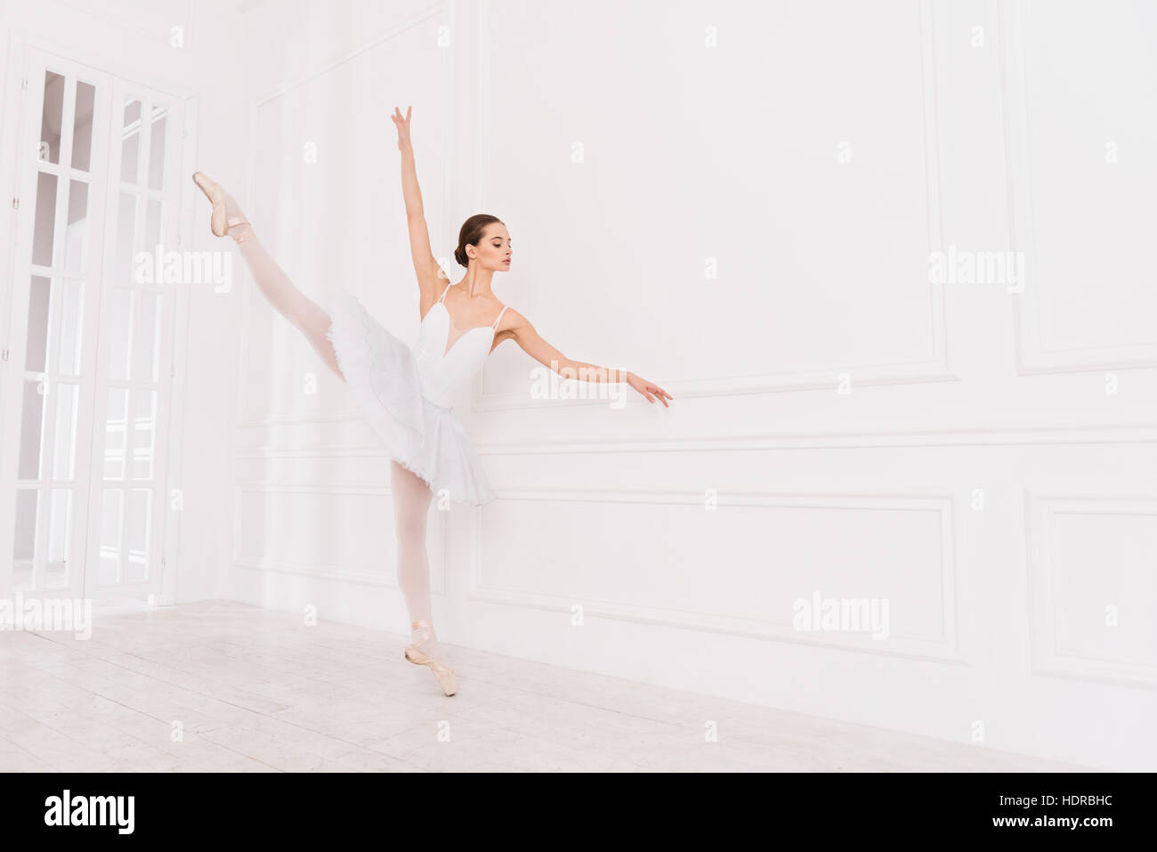 Graceful female posing with diagonal legs Stock Photo - Alamy
